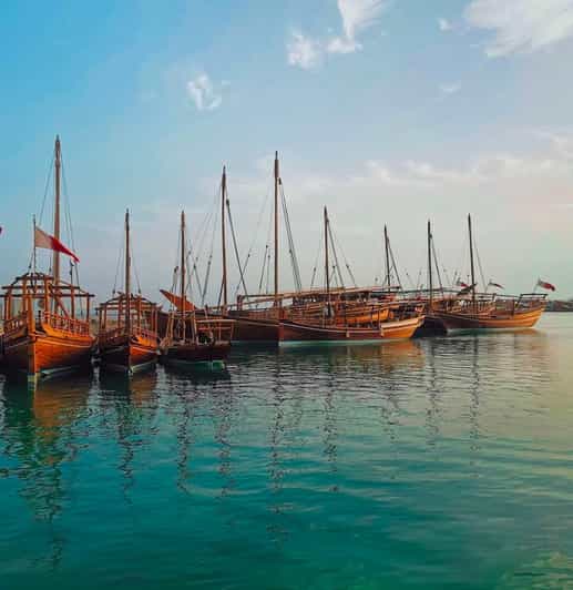 Doha: traditional Dhow Harbour, Skyline view , Sunset | GetYourGuide