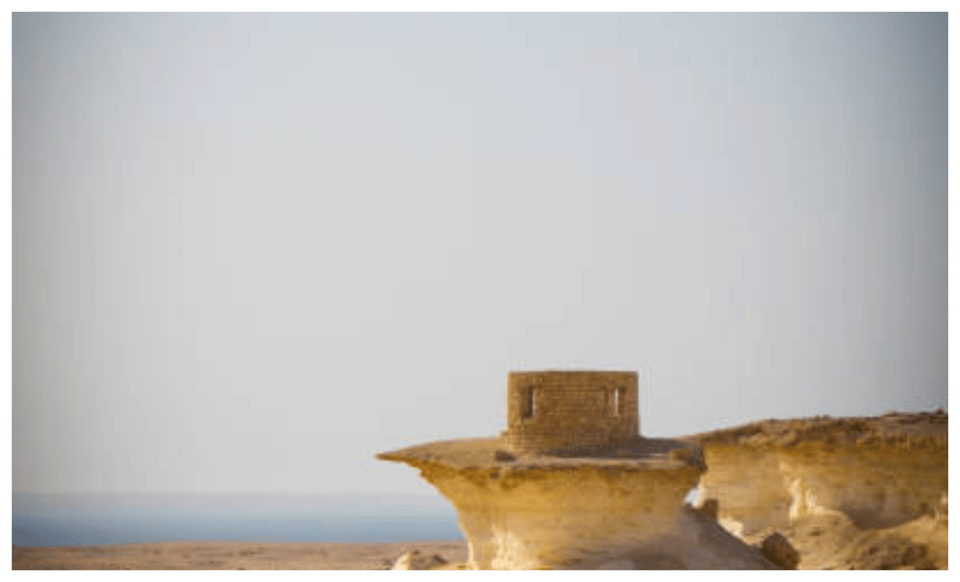 Doha:West tour to Richard Sierra sculpture, Umbrella Rock | GetYourGuide
