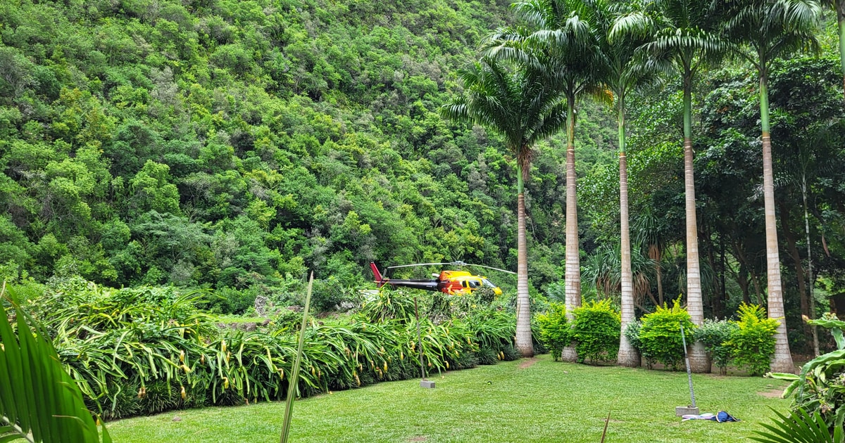 Helicopter flight over the waterfalls and basins of Reunion Island with ...