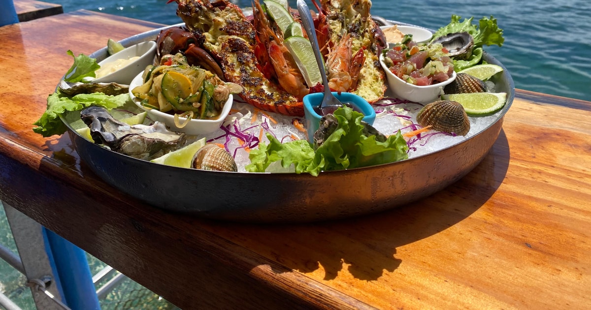 Noumea: Pontoon Day Trip with Seafood and Swim with fishs | GetYourGuide