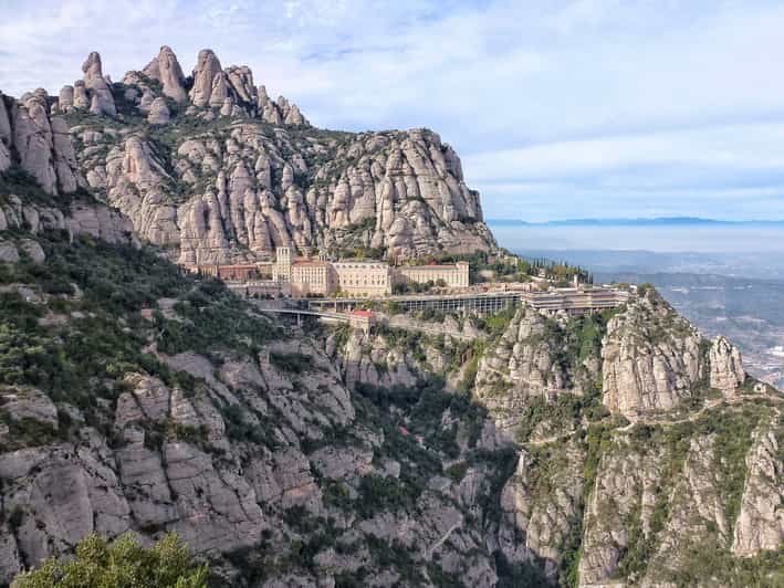 Montserrat Royal Basilica With Cog-Wheel Train or Bus | GetYourGuide
