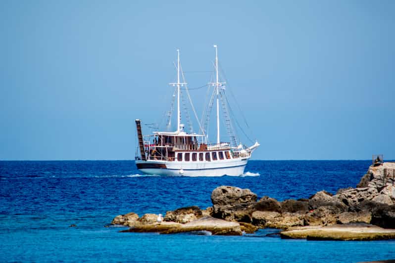 Rhodes: Boat Cruise with Food, Drinks, SUP, Kayak & Swimming | GetYourGuide