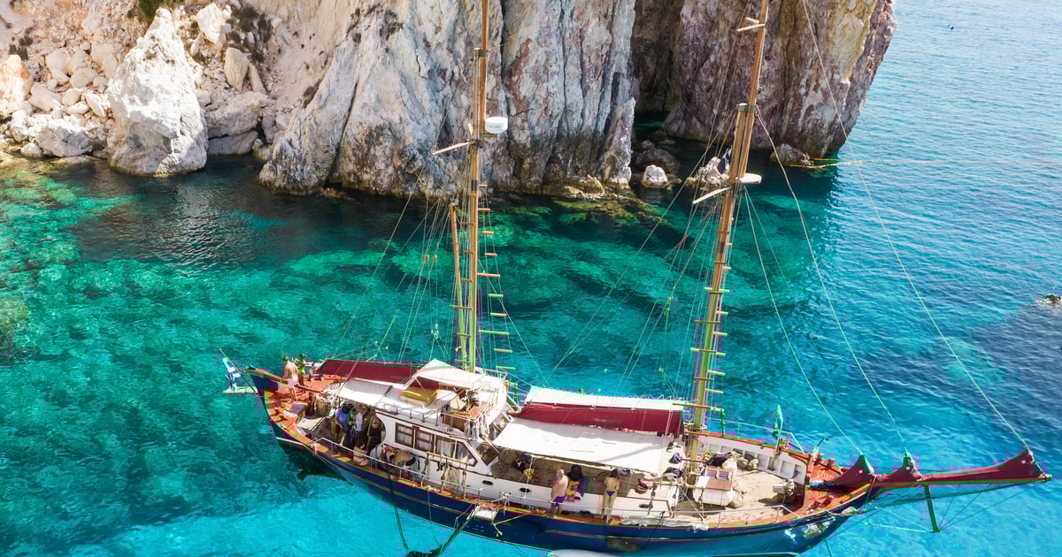 Milos: Cruise via Traditional Boat with Beach and Cave Stops | GetYourGuide