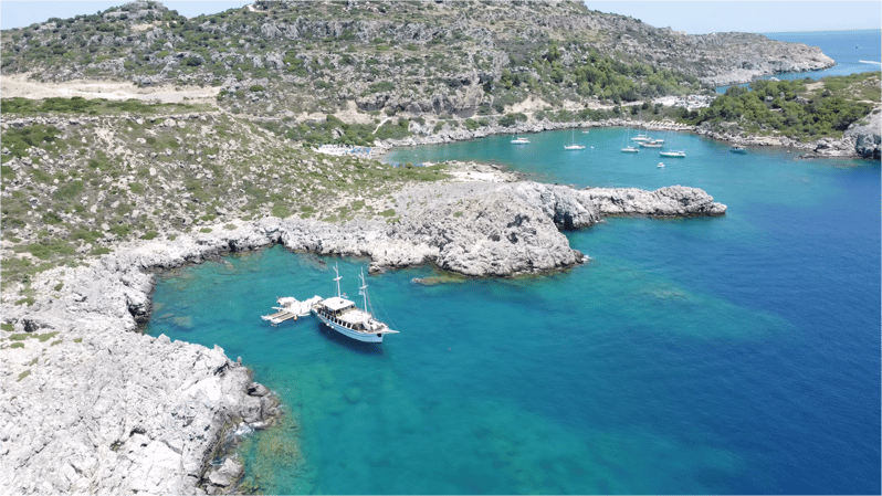 Rhodes: Boat Cruise with Food, Drinks, SUP, Kayak & Swimming | GetYourGuide