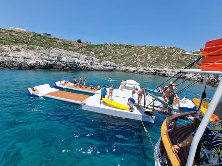 Rhodes: Boat Cruise with Food, Drinks, SUP, Kayak & Swimming | GetYourGuide