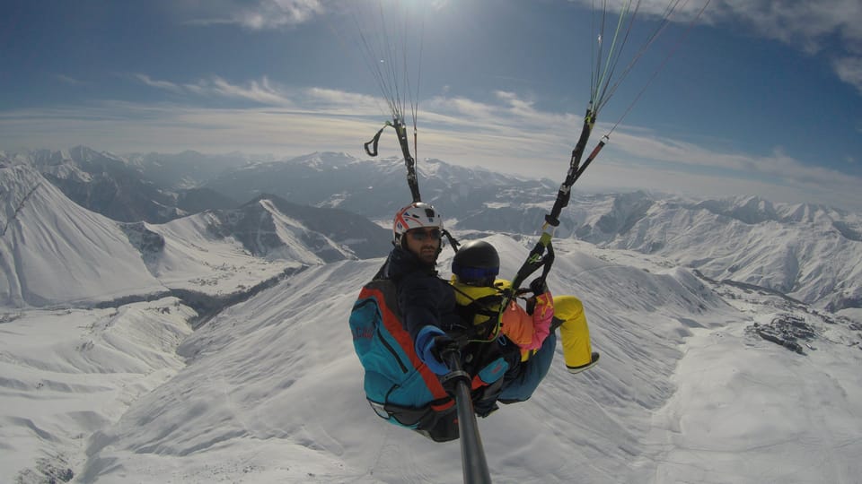 Georgia: Paragliding flight in the mountains and video of it | GetYourGuide