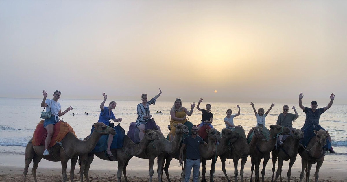 Caves, sunset, camel ride on the beach and barbecue dinner | GetYourGuide