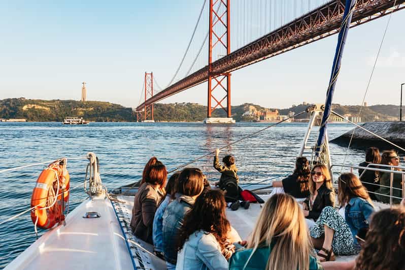Lisbon: Sunset Catamaran Tour with Music and Drink | GetYourGuide