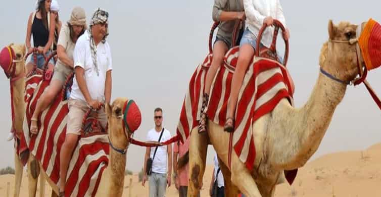 Dubai: Desert Safari, Live Shows, BBQ, Camel & Sand Ride | GetYourGuide