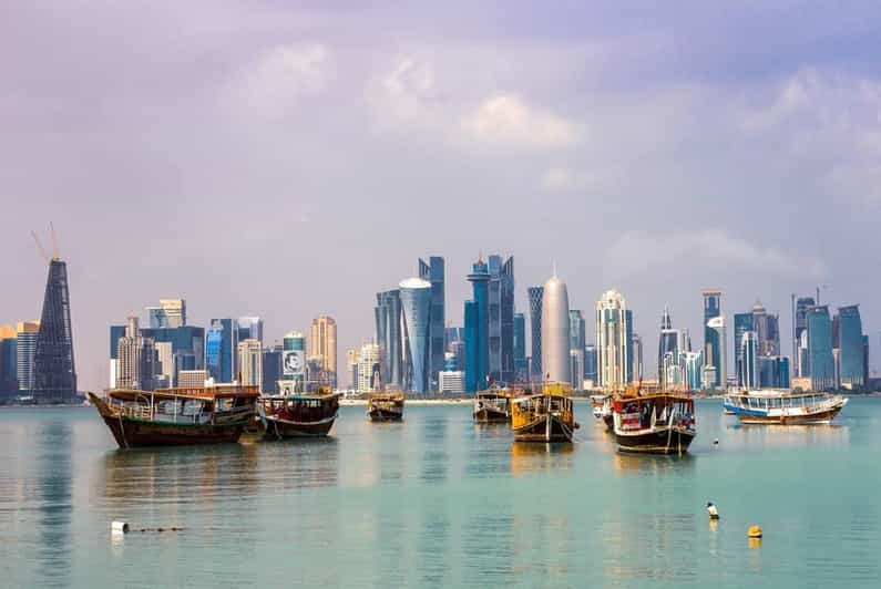 Doha: traditional Dhow Harbour, Skyline view , Sunset | GetYourGuide